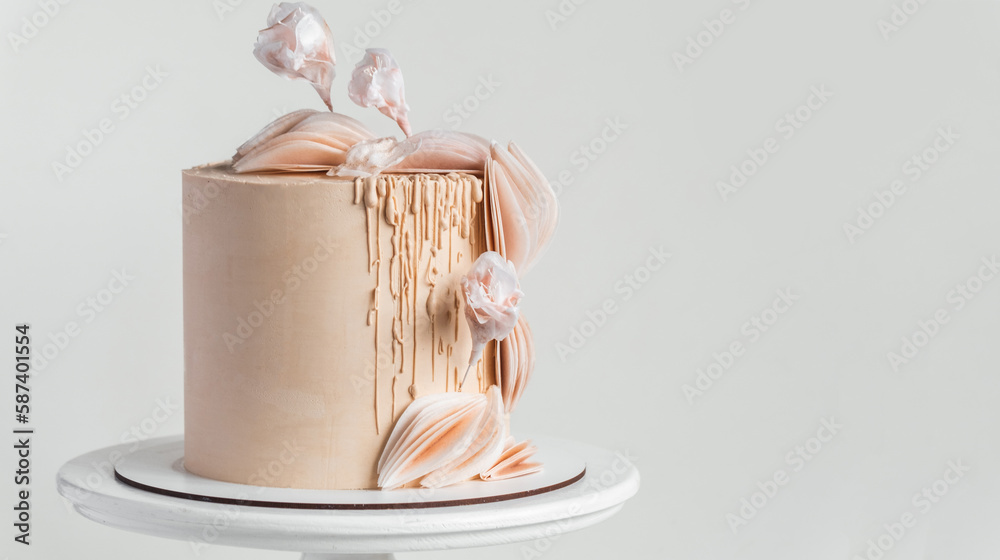 Beautiful big cake with beige chocolate icing decorated with edible ...