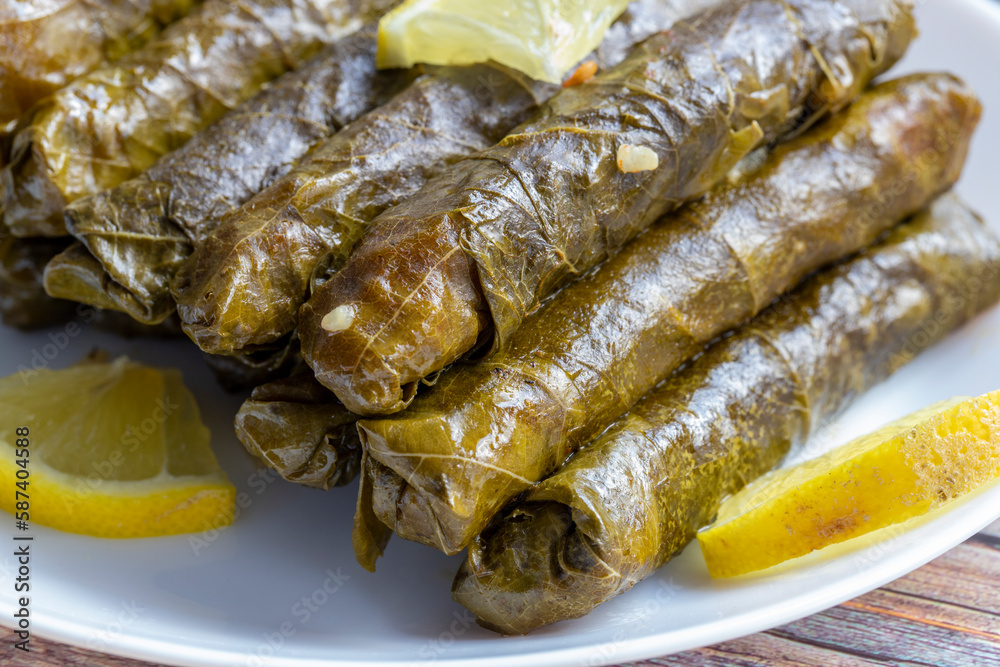 Delicious dolma (sarma) stuffed grape leaves rice, white yogurt sauce. Lebanese dolma sarma on ...
