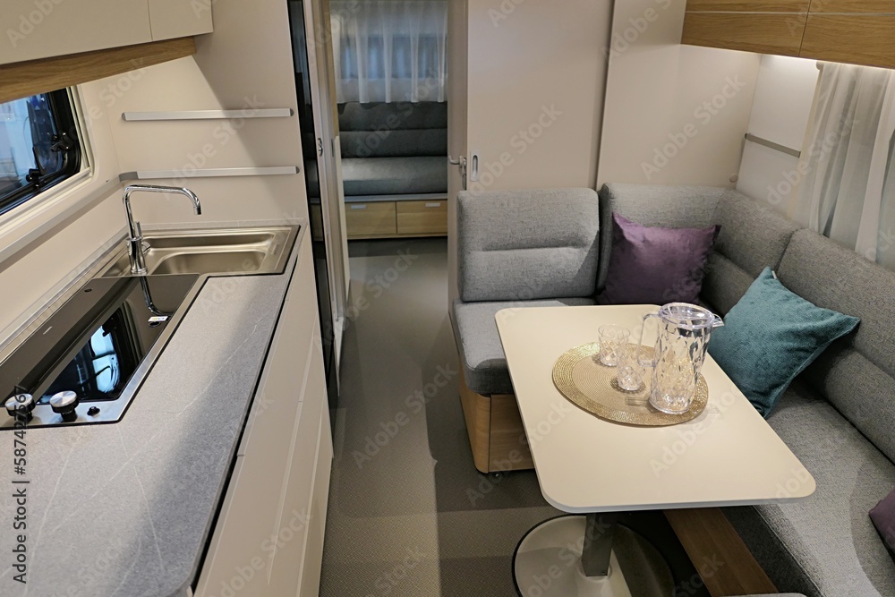Kitchen corner and dining table with seats in modern Slovenian camper ...