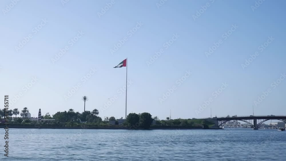 Sharjah, the UAE flag flies from a huge pole in the sky over Flag ...
