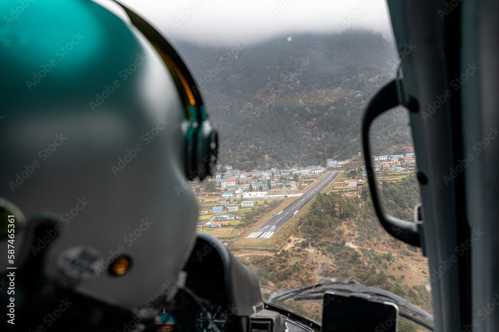 Interior photo of a Nepali helicopter pilot preparing to safely land on ...
