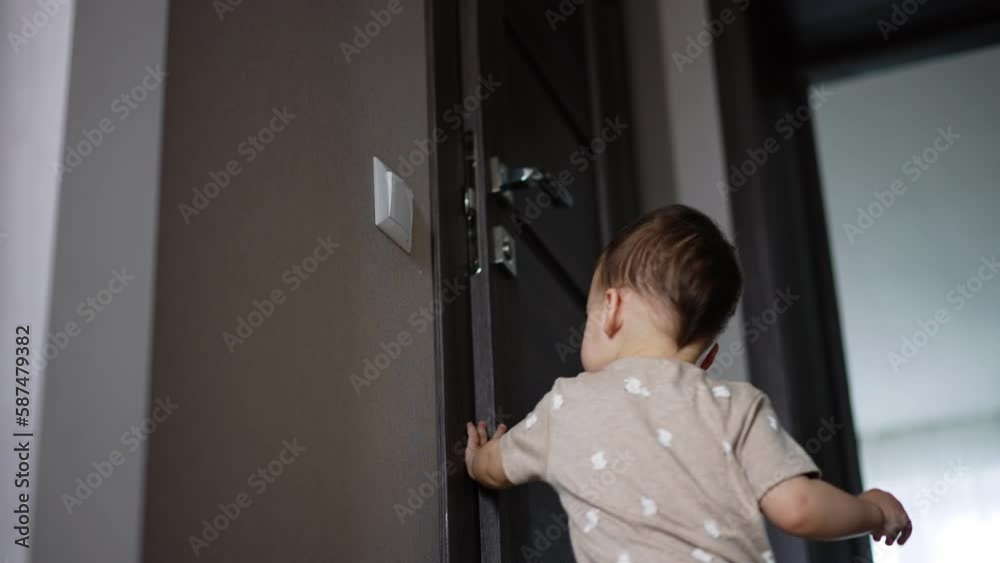 Baby comes up to the door a little bit opened. Kid closes the door and ...
