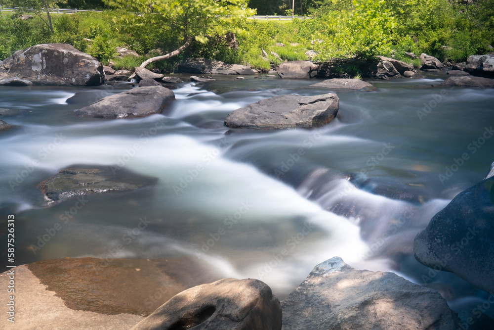 Fast moving stream water captured with a slow shutter creating a ...
