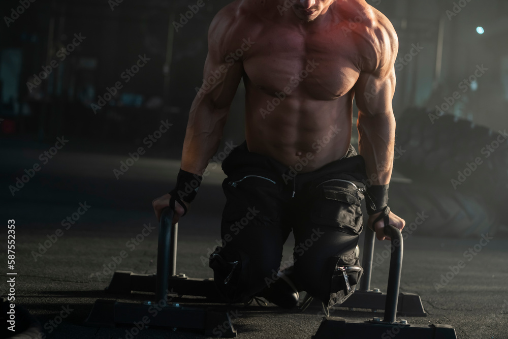 Young muscular man performing masculine bodybuilding exercise by doing ...