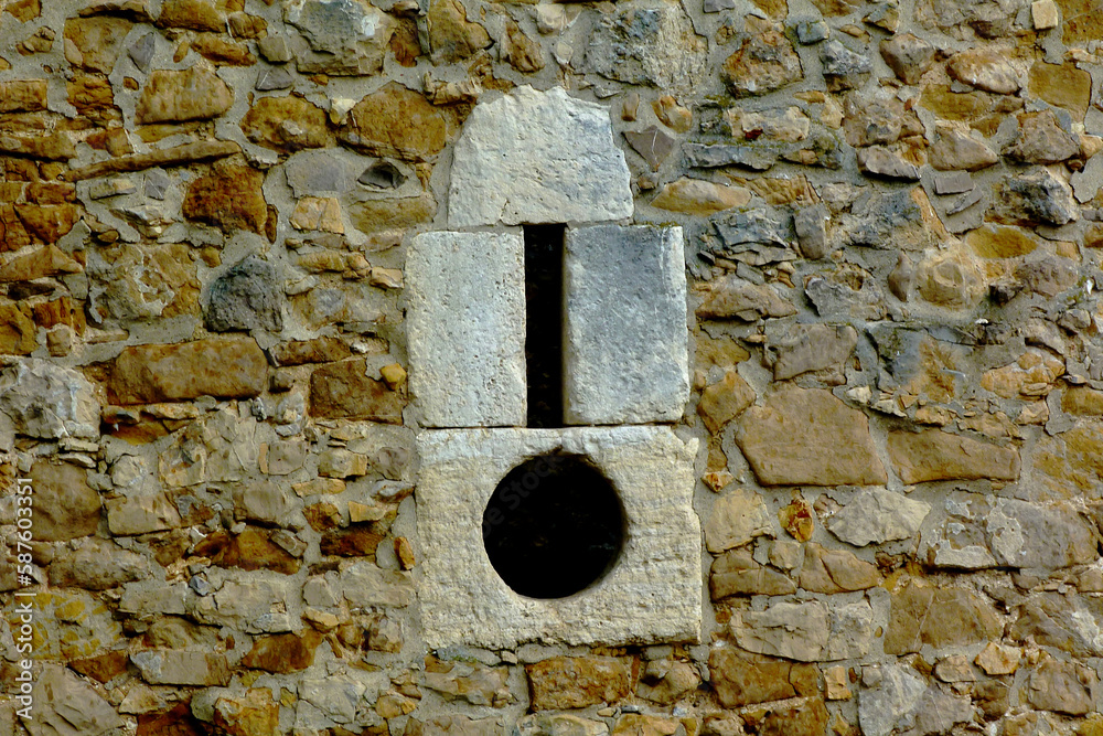narrow light color stone arrow slit in exterior fortress wall ...