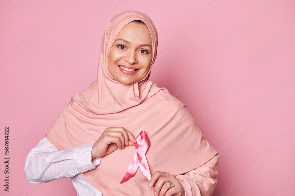 Confident portrait of a friendly Arab Muslim woman wearing a hijab and ...