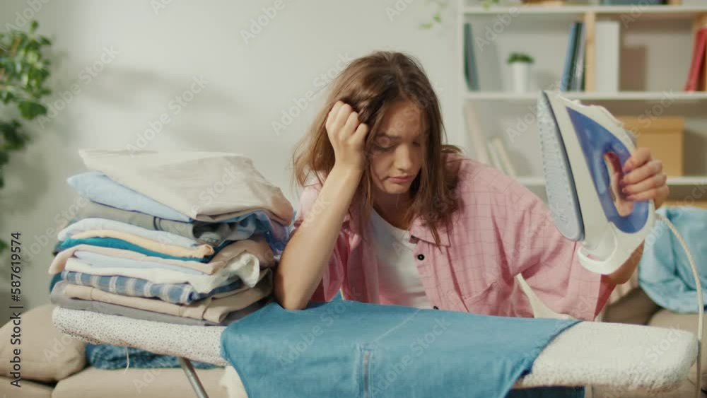 Tired Housewife Woman Ironing Clothes at Home. A Woman Housekeeper is ...