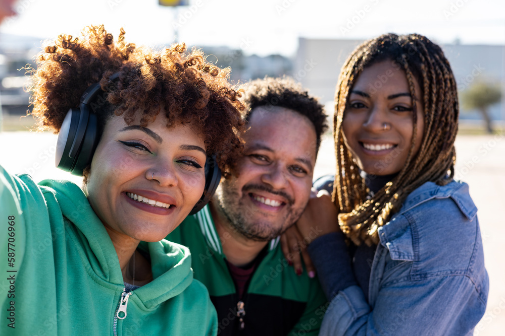 A group of happy and diverse multi-ethnic friends gather together on a ...