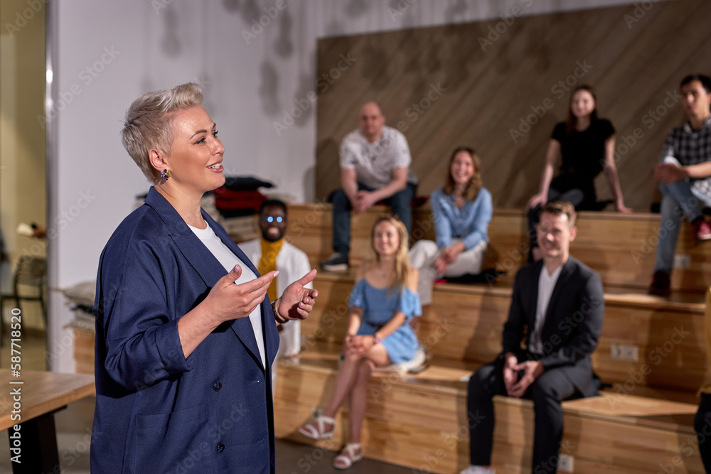 Female Lecturer In Formal Wear Smiling, Holding Conference Lecture To ...