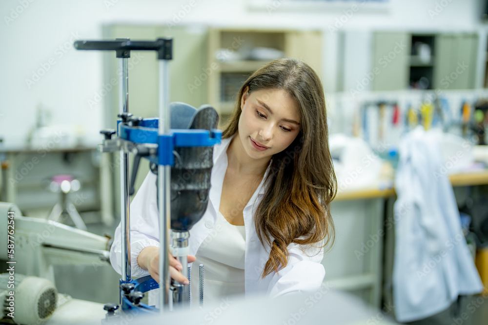 Production of a prosthetic leg. A woman creates part of the leg. An ...