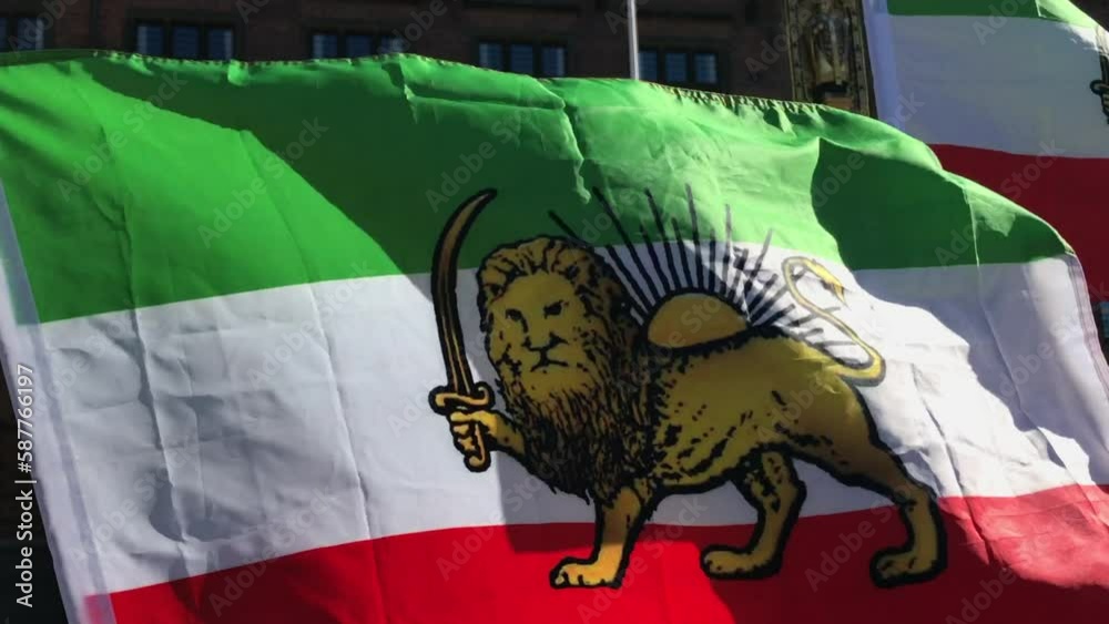 Iran waving pre-revolutionary Lion and Sun flag. Close up film clip ...
