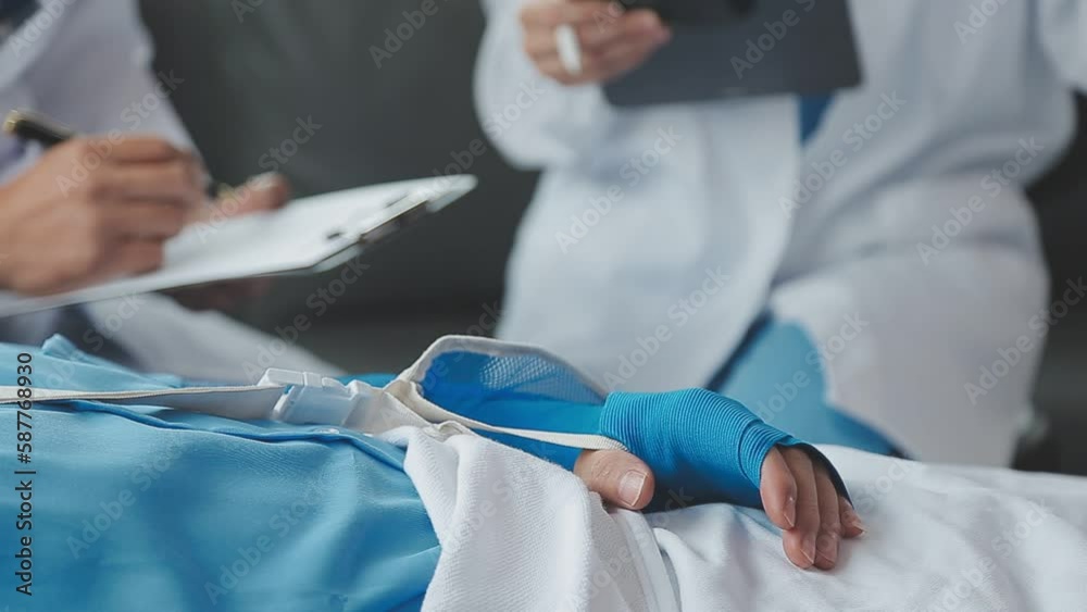 Man with broken arm in cast lying on bed in hospital. The emergency ...