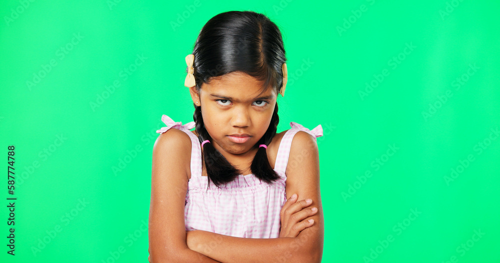 Angry, crossed arms and face of child on green screen with upset ...