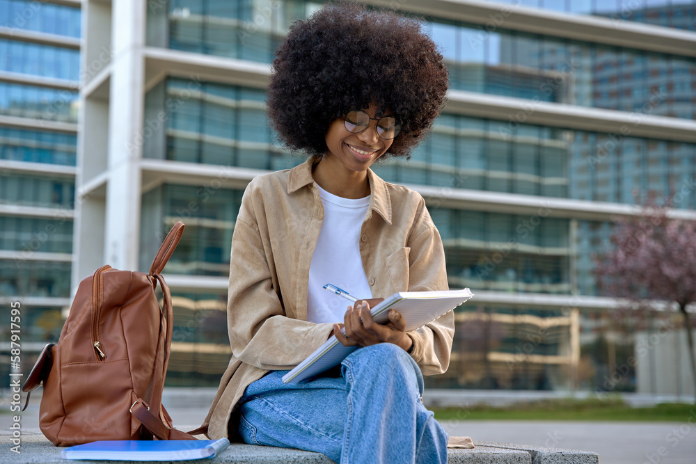 Happy young black African American woman university student doing ...