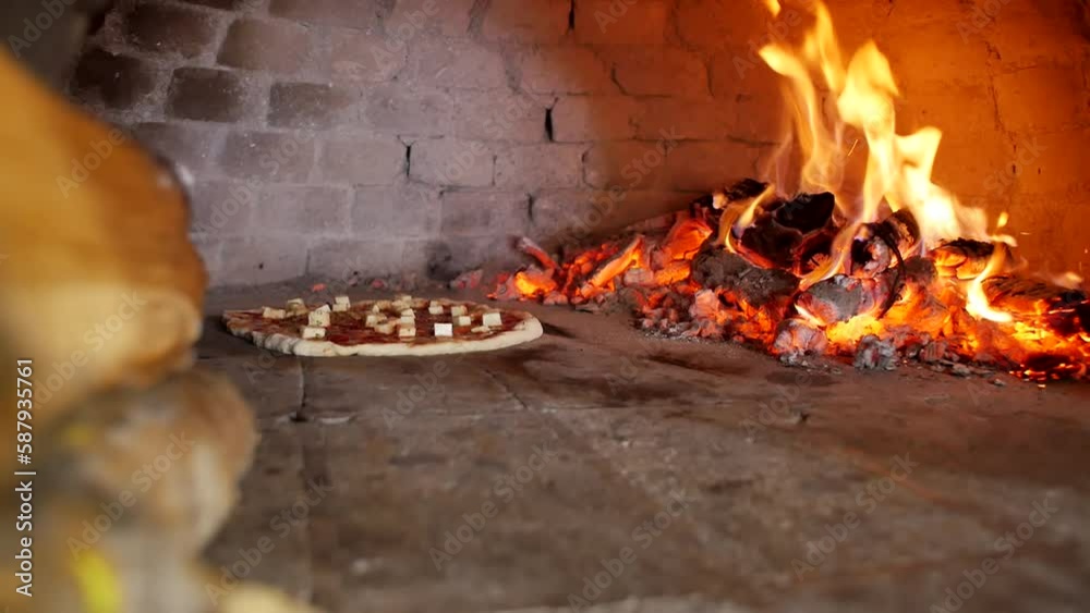 In a stone hot traditional oven, Italian pizza is baked closely with ...