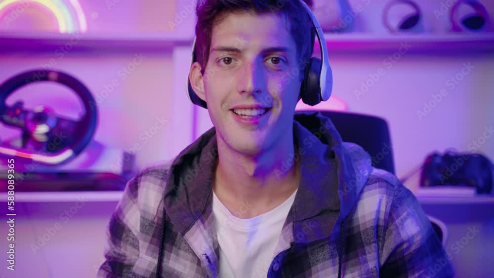 male influencer gamer wearing on headphones before streaming in ...