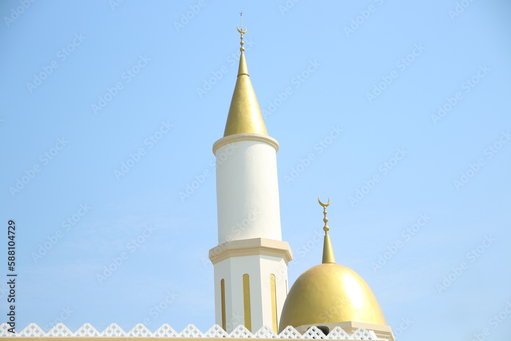 Gold dome and Minaret of the masjid sign of Islam blue sky background ...