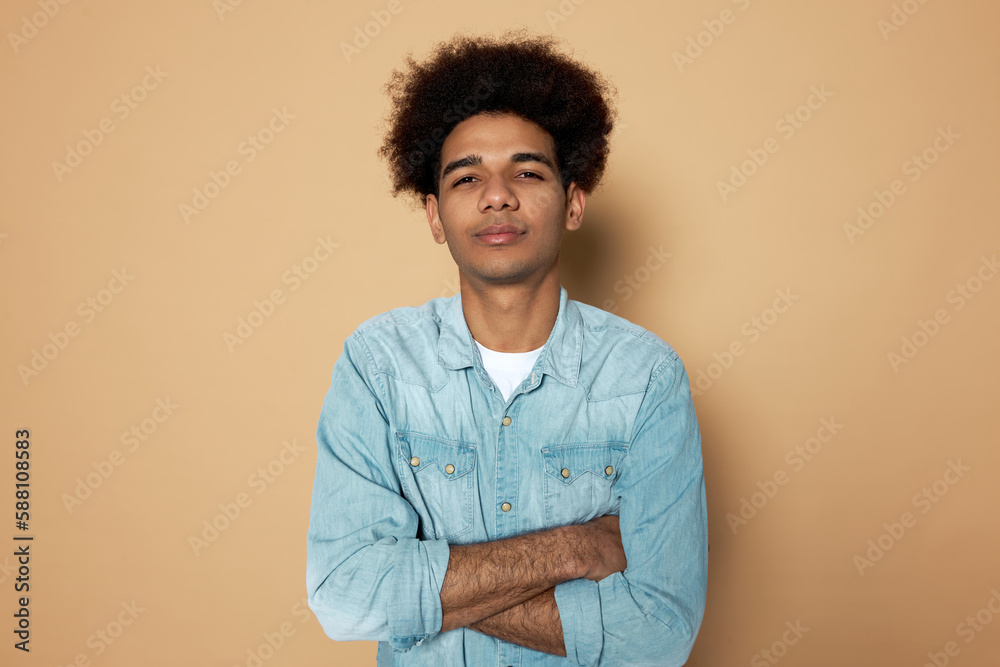 Image of cute young stylish guy standing against brown studio ...