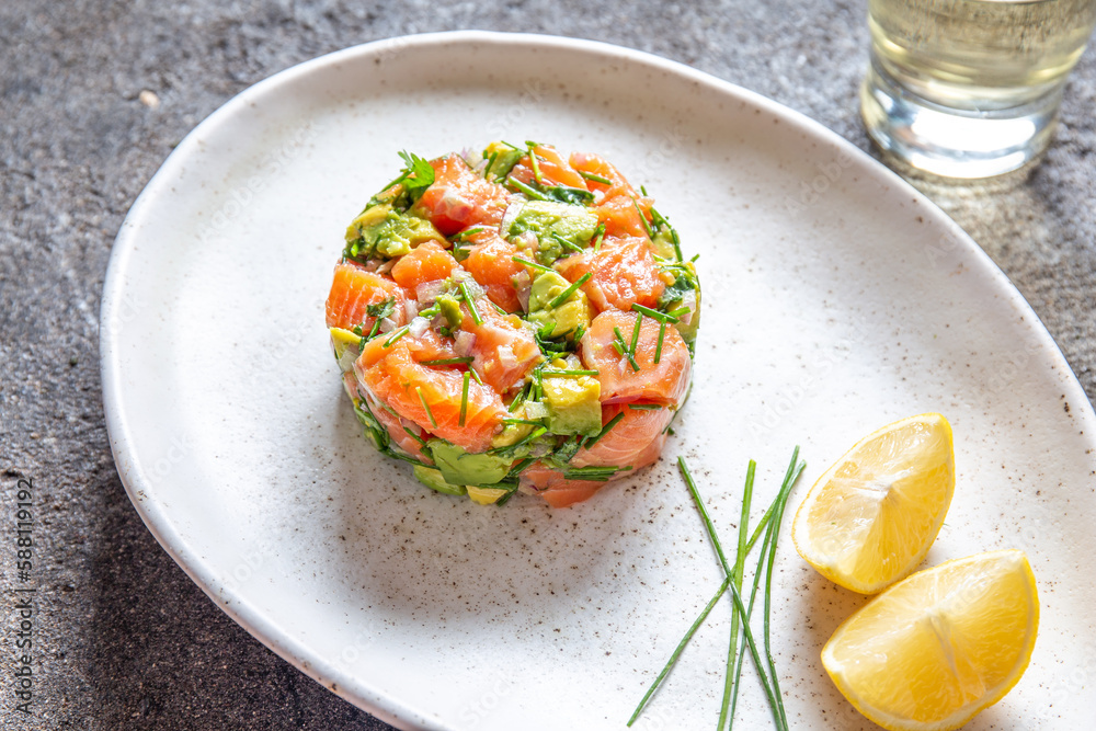 PERUVIAN FOOD. Salmon ceviche with avocado, spring onion and lemon on ...