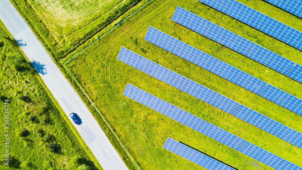 Top down view of solar panels. Solar power plant and road with moving ...