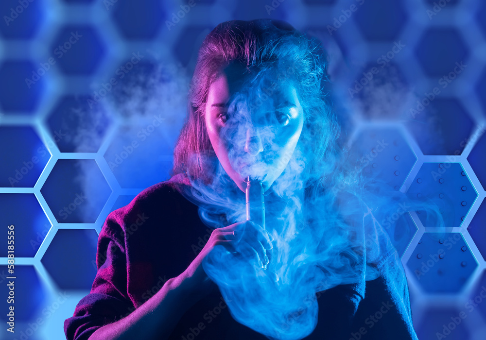 Woman vaper. Girl face is hidden in smoke. Vaper smokes electronic ...