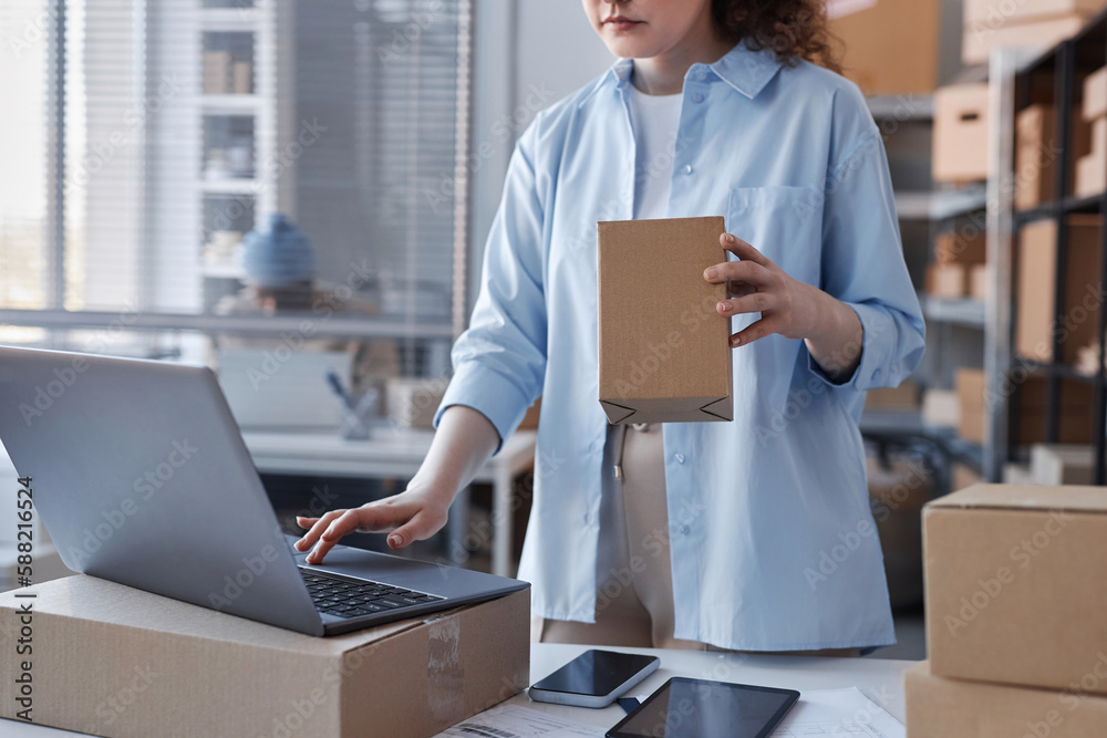 Cropped shot of young female worker of post office checking address of ...