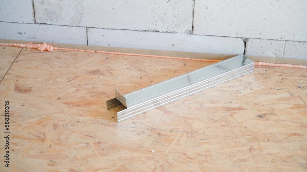 Galvanized metal U profile lies on the osb plate at the construction ...