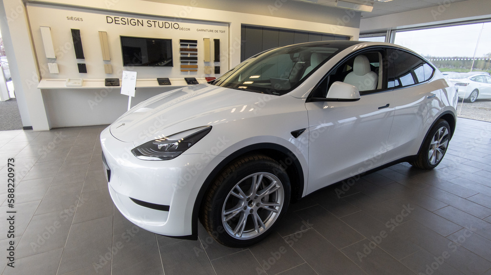 tesla Model y white electric car vehicle ev in dealership new sale ...