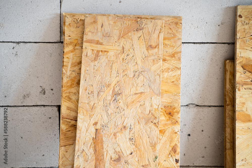 Scraps of osb slabs. The remains of a wood slab at a construction site ...