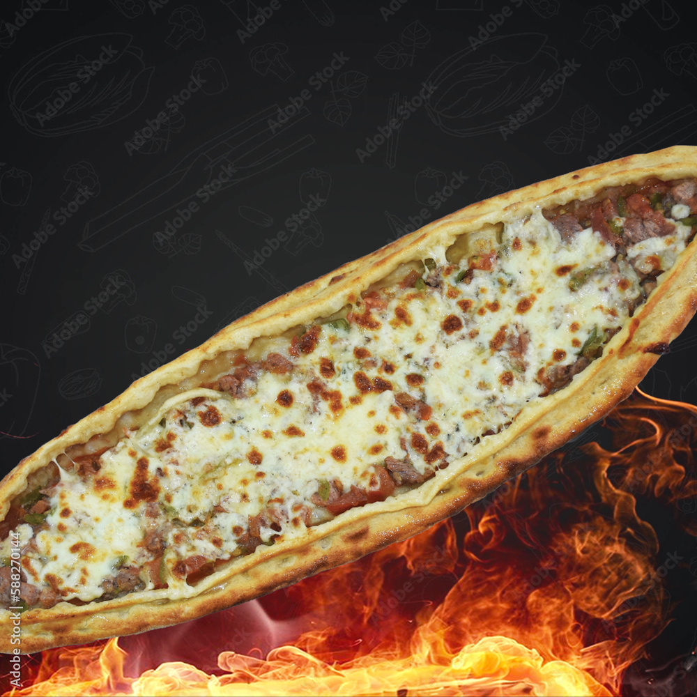 Turkish pizza with cubed meat and melted cheese isolated on flames with ...