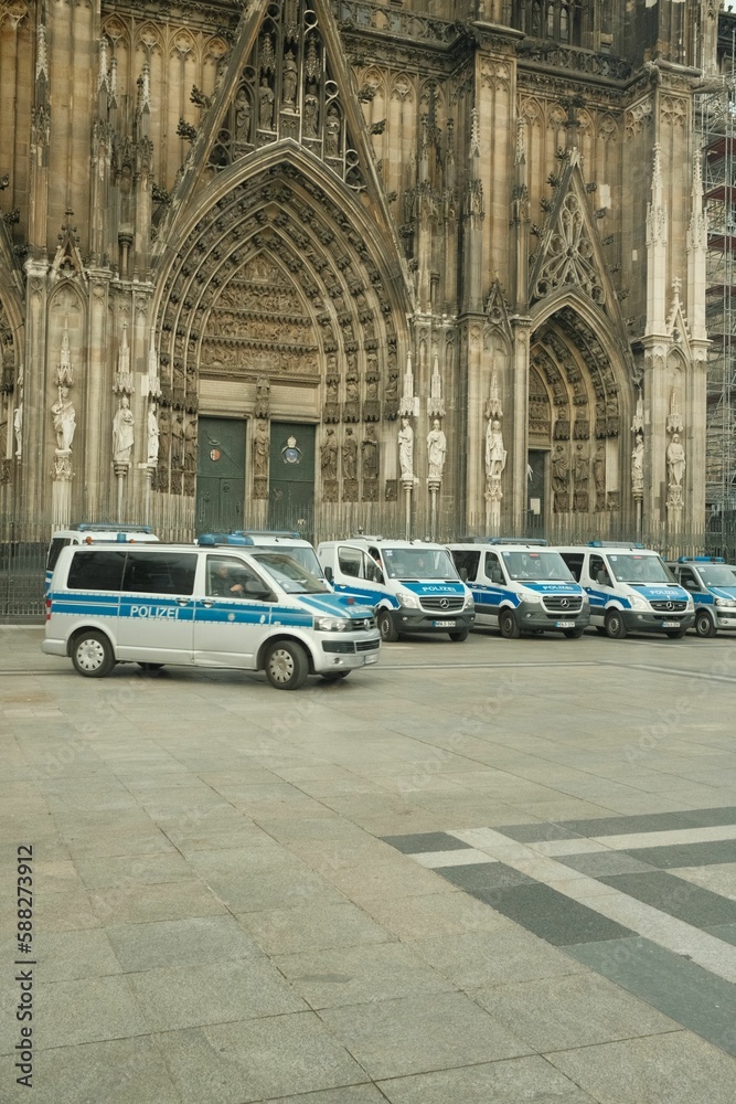 Row of Mercedes-Benz Sprinter police cars in front of Cologne Cathedral ...