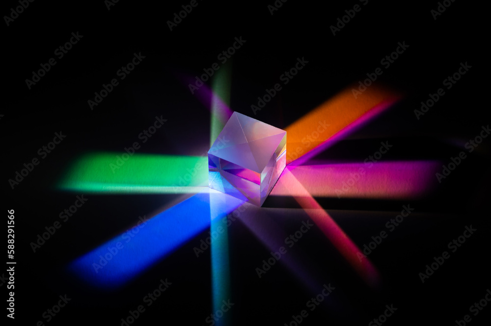 Spectral decomposition of a light ray into colors. A glass cube ...