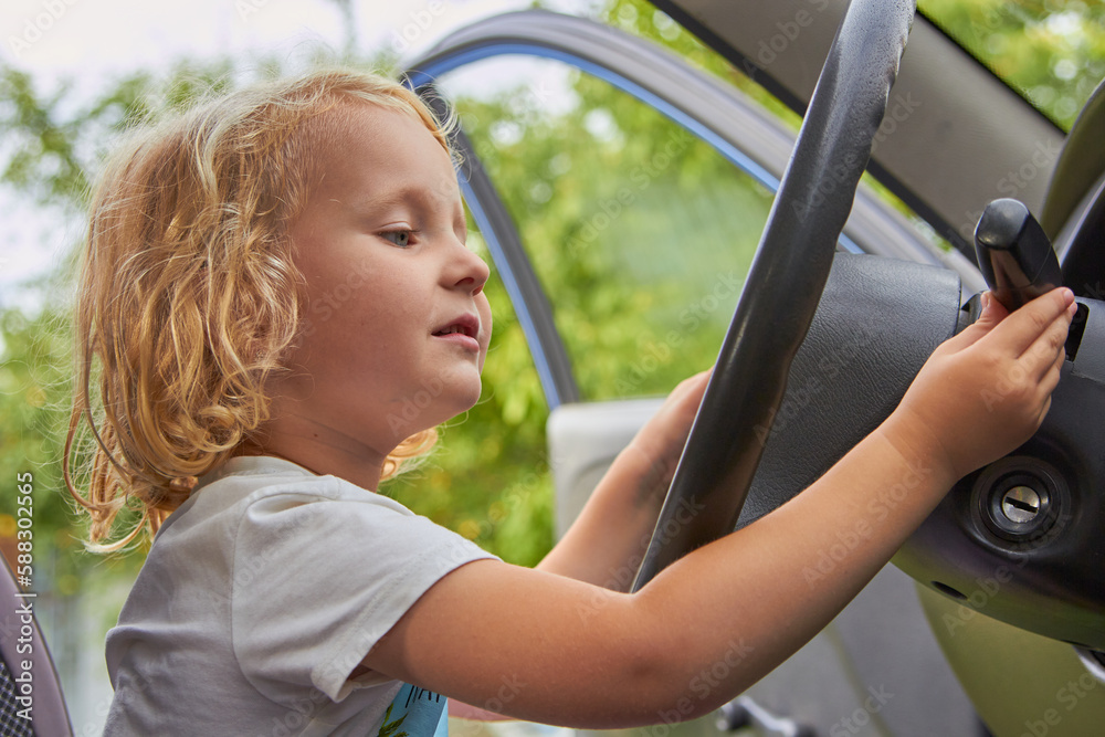 a child driving a car,happy little girl playing in the car in the ...