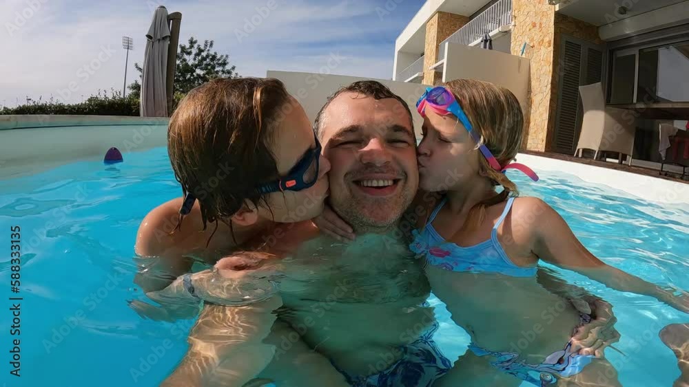 A 40-year-old caucasian father with slight stubble enjoys a summer sun ...