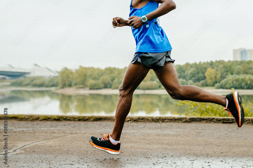 male african runner athlete running marathon race in embankment river ...