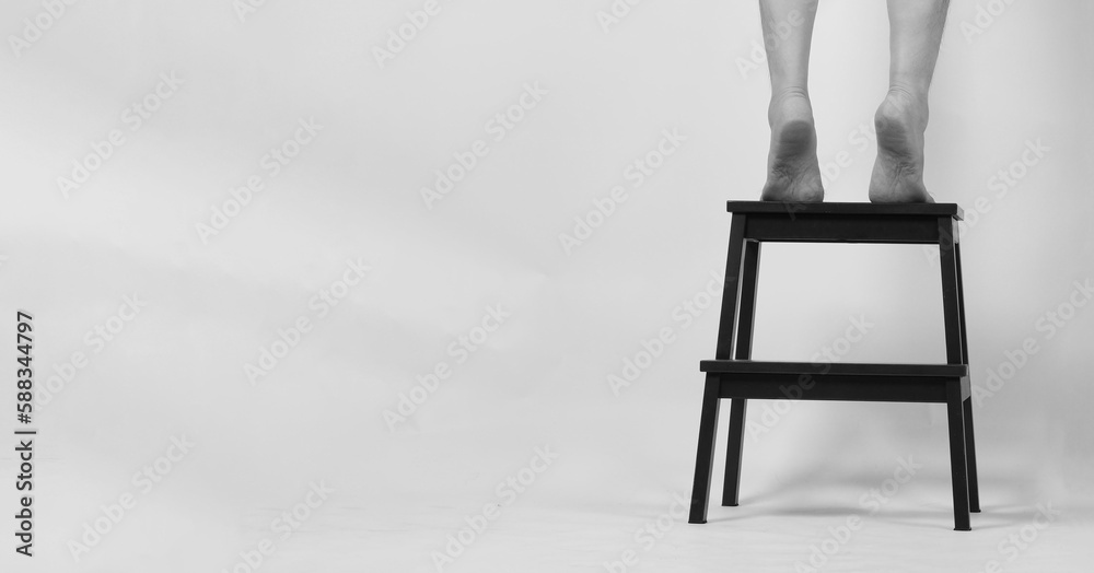 Legs and Barefoot stand on a step stool or wooden stairs with white ...