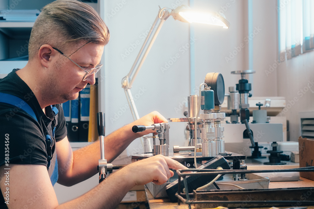 Professional calibration of pressure gauges and sensors. Working man is ...