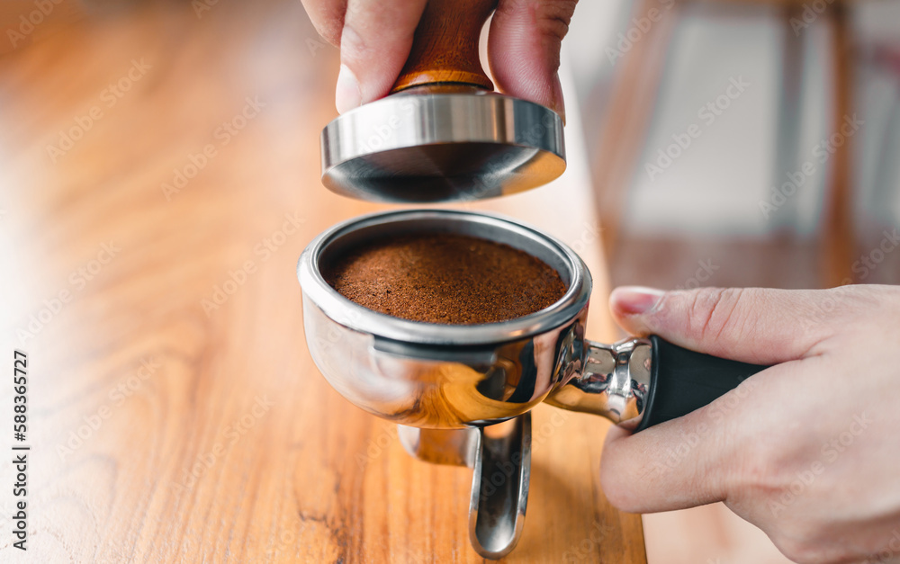 Close-up of hand Barista cafe making coffee with manual presses ground ...
