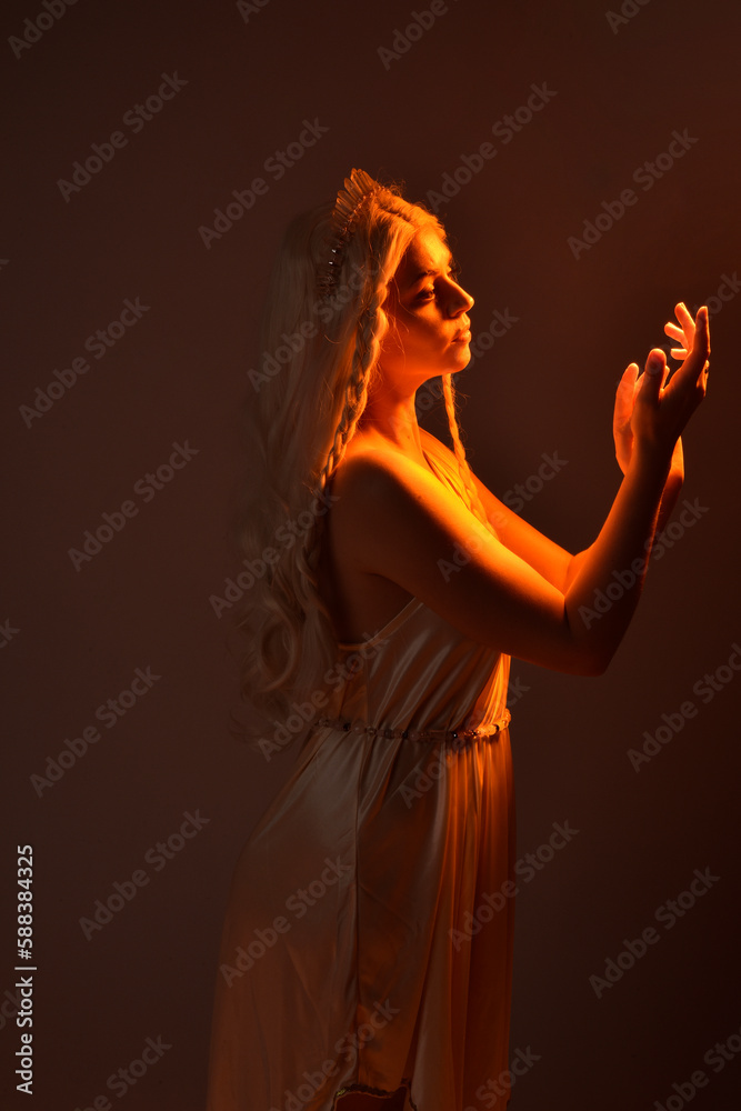 portrait of beautiful blonde woman wearing a fantasy goddess toga ...