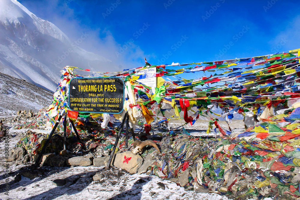 The Thorung La Pass signboard greets trekkers as they reach the high ...