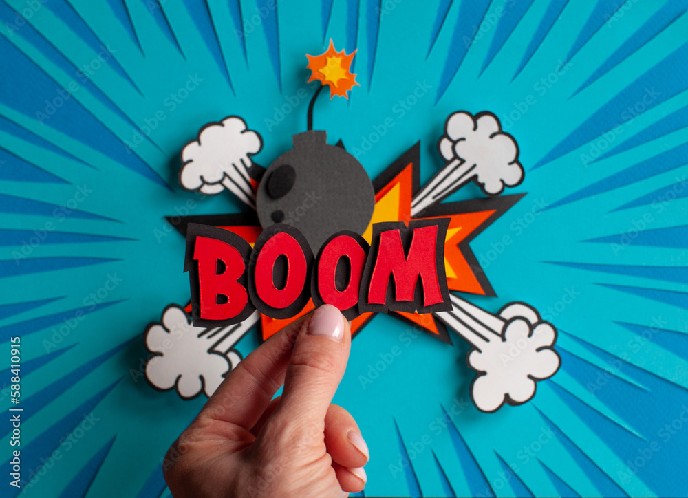 Handmade word boom in hand on comic background. Pop art and comic style ...