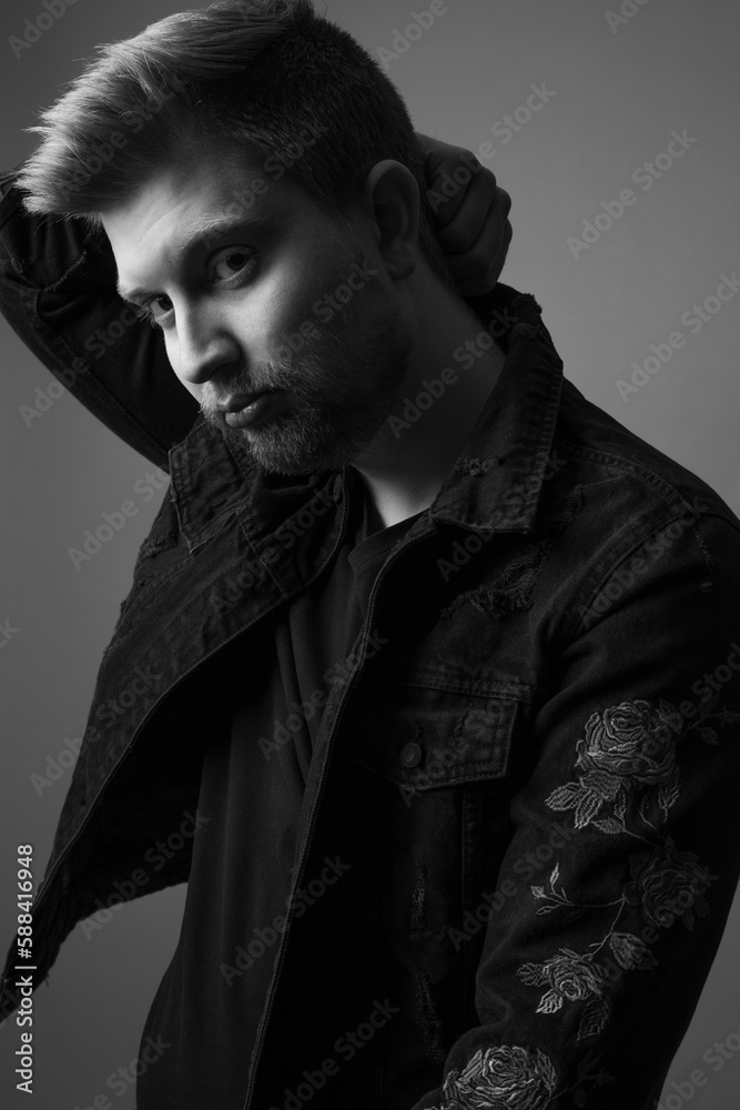 Black and white studio portrait of a handsome male model wearing a ...