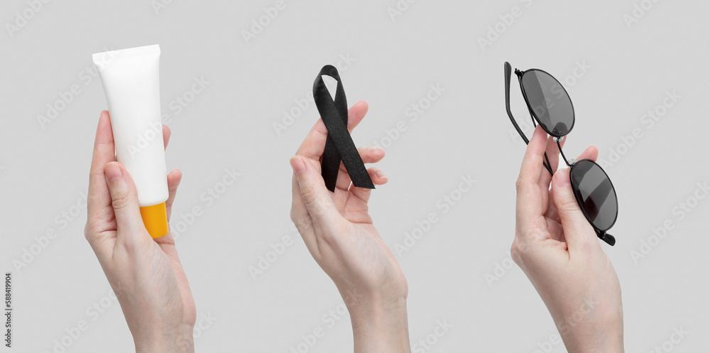 Woman in hand holding sunscreen, sunglasses and black ribbon symbol for ...