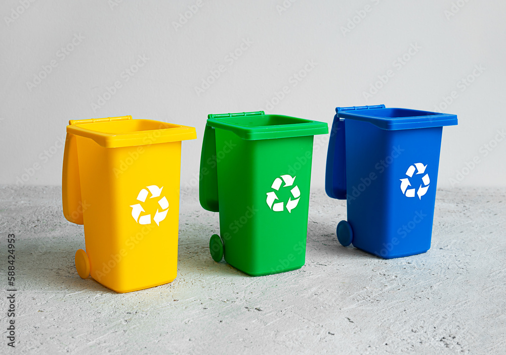 Blue, yellow and green open tank for separate garbage collection on a ...