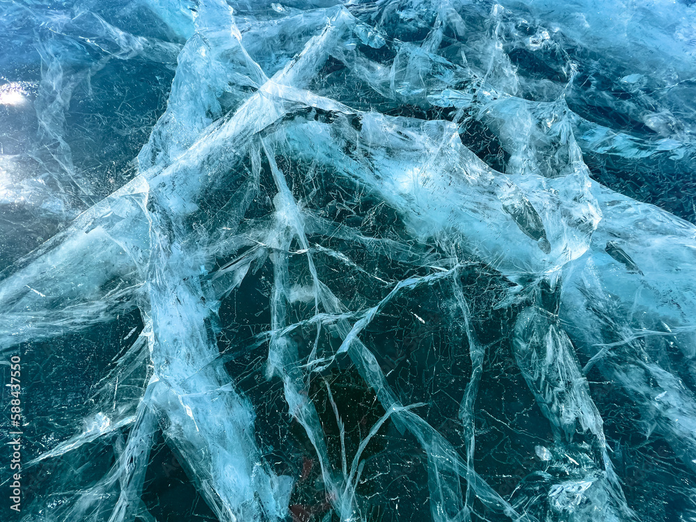 The natural texture of winter ice with white bubbles and cracks on a ...