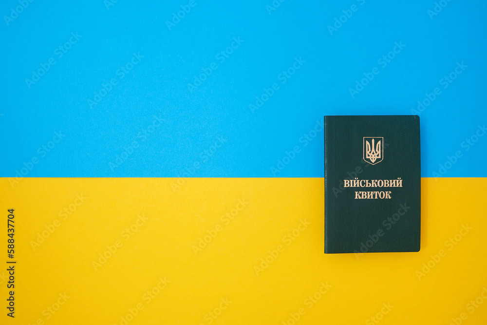Ukrainian green military ID ticket on the Ukrainian national flag in ...