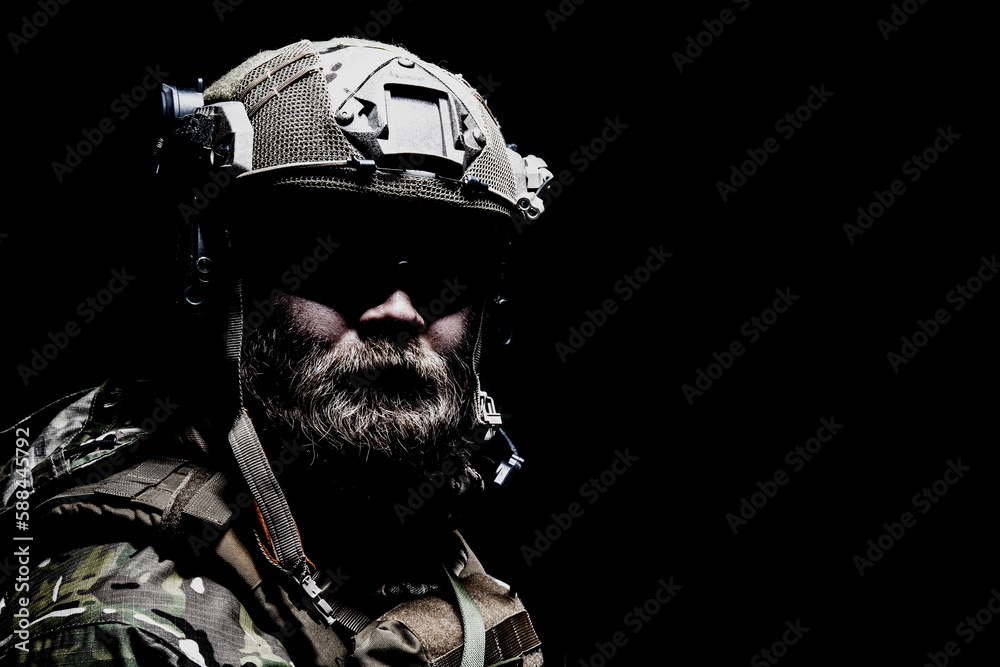 Close up, low key half length portrait of bearded commando fighter ...