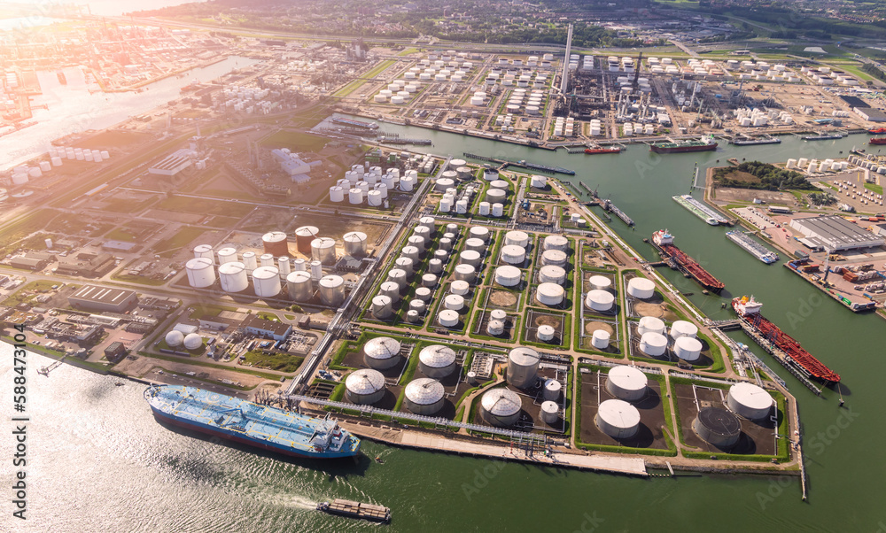 Aerial view of oil tankers and storage silo tanks at a petrochemical ...