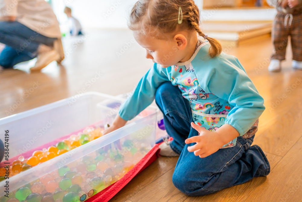 Little girl playing with sensory water beads, hydrogel balls. Sensory ...