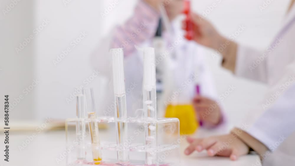 Close up shot of a science experiment in the school lab, drop of liquid ...